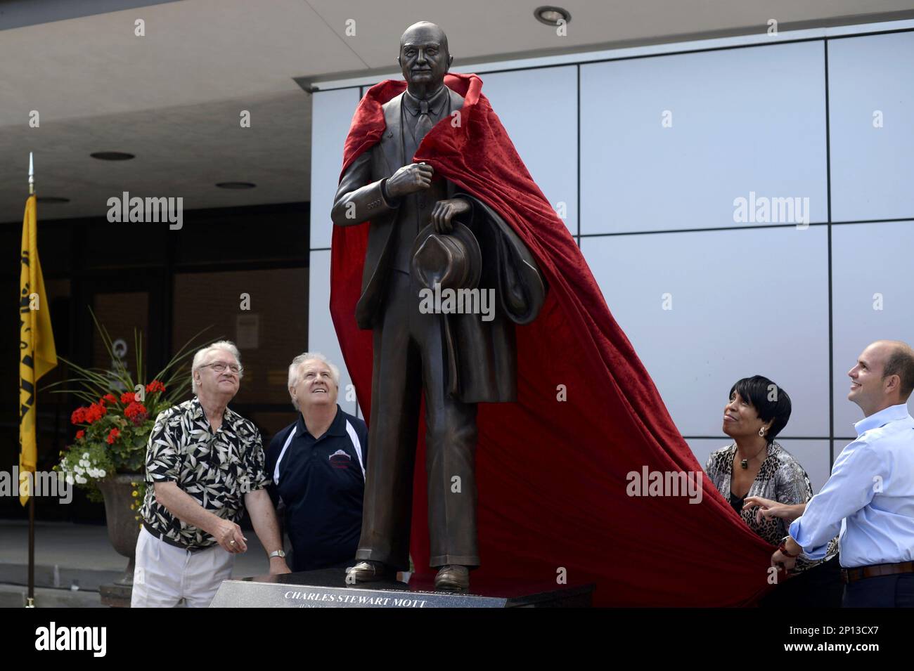The Charles Stewart Mott statue is unveiled during a ceremony on ...