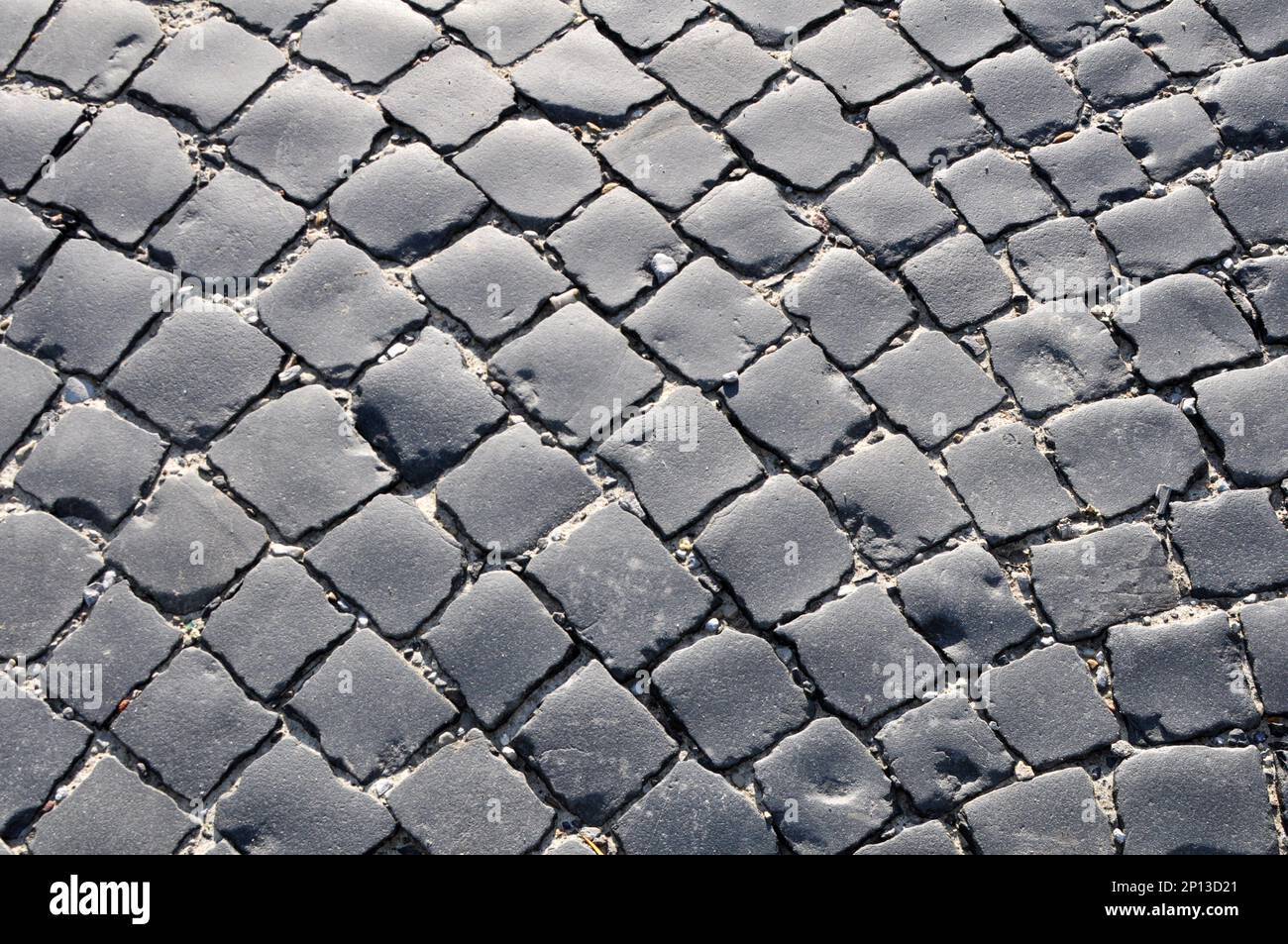 Old stone cobblestones from which the road is paved Stock Photo - Alamy