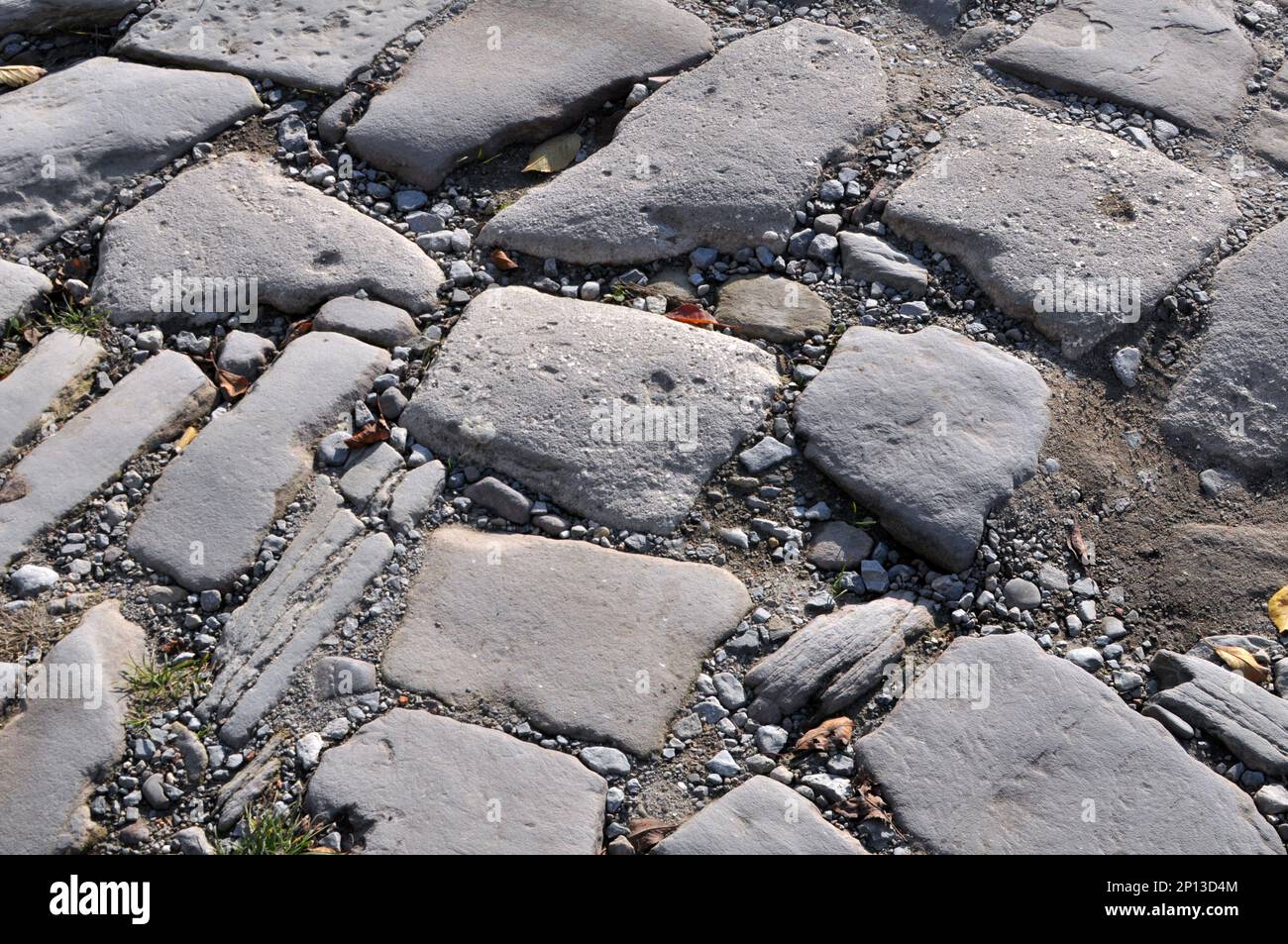 Old stone cobblestones from which the road is paved Stock Photo - Alamy