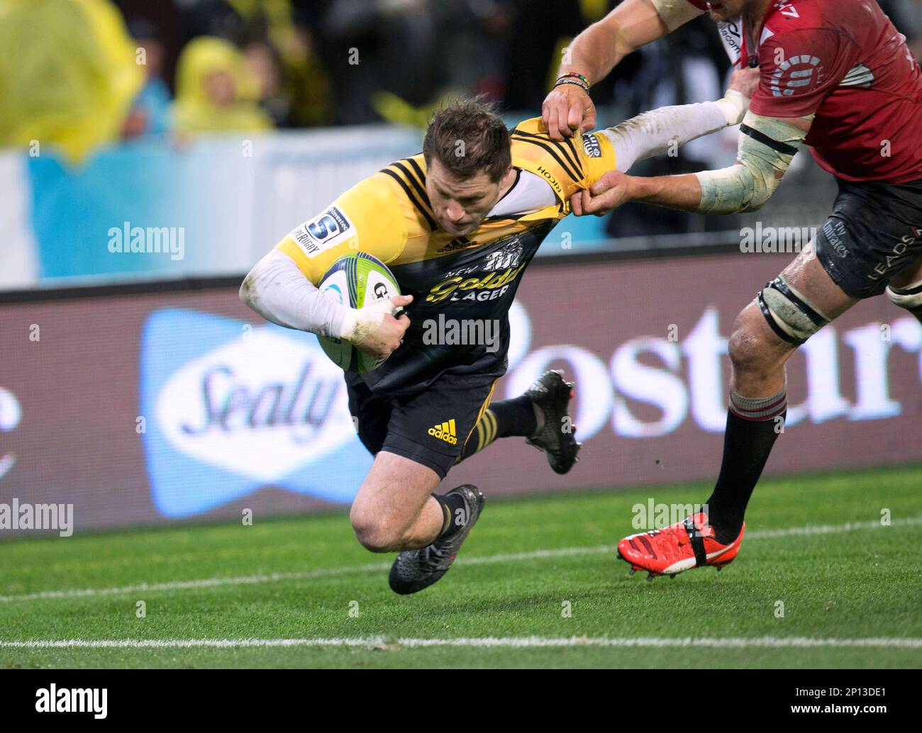 The Hurricanes Cory Jane left scores a try as the Lions Franco Mostert tries to hold him back during the Super Rugby final in Wellington New Zealand Saturday Aug. 6 2016. The