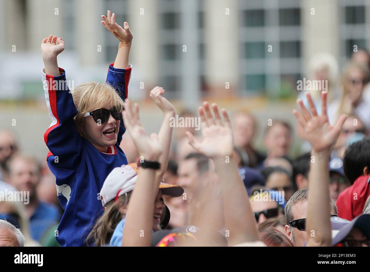 A young fan cheers as the National Hockey League announce the rosters ...