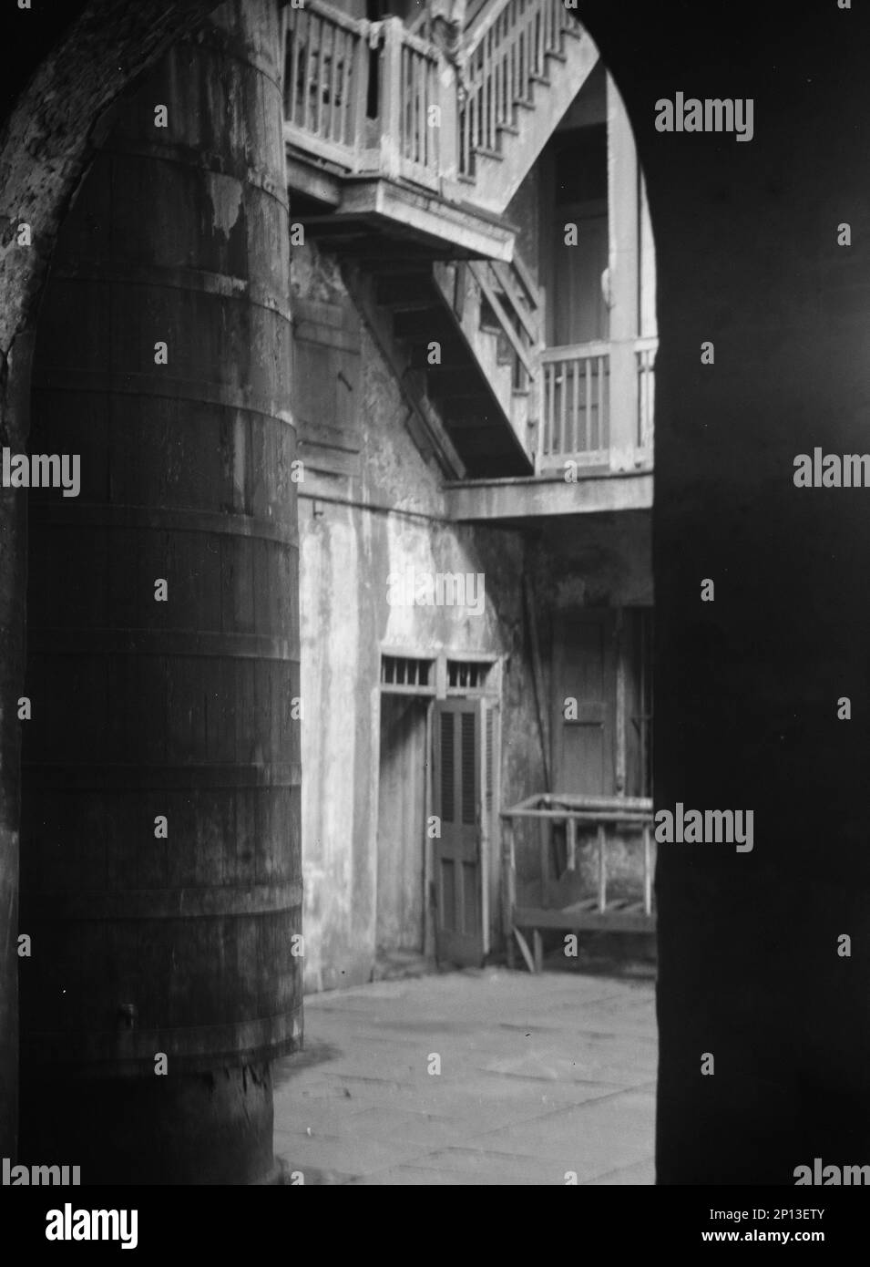 Cistern and outer stairs of an old-time courtyard, New Orleans, between ...