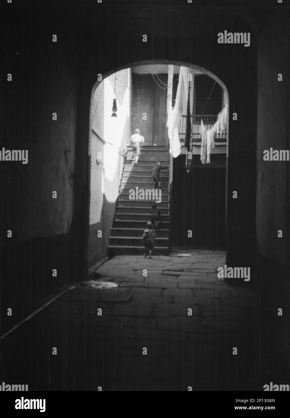 View of a courtyard through an arched passageway, New Orleans, between ...