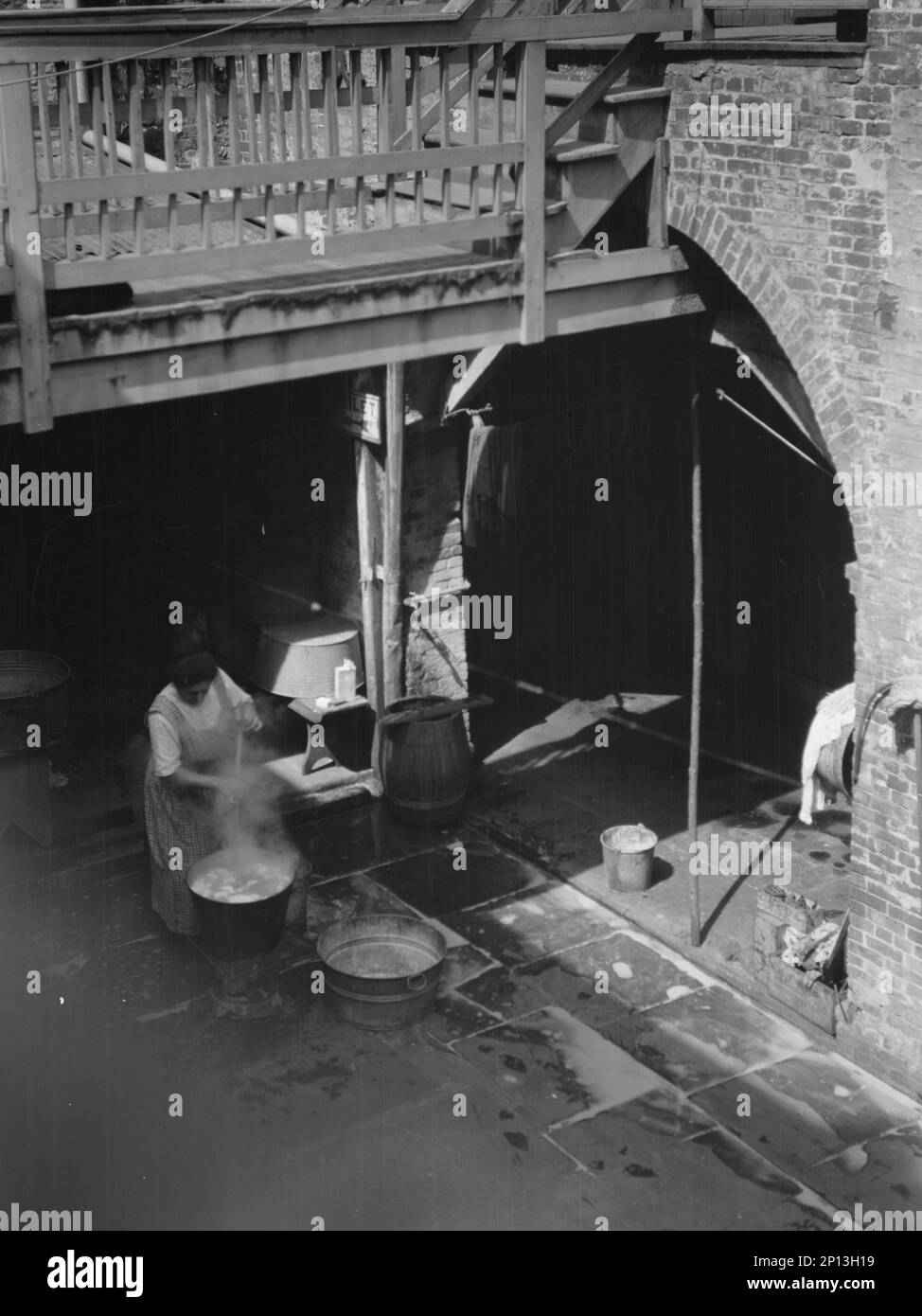 Woman doing laundry in a courtyard, New Orleans, between 1920 and 1926 ...