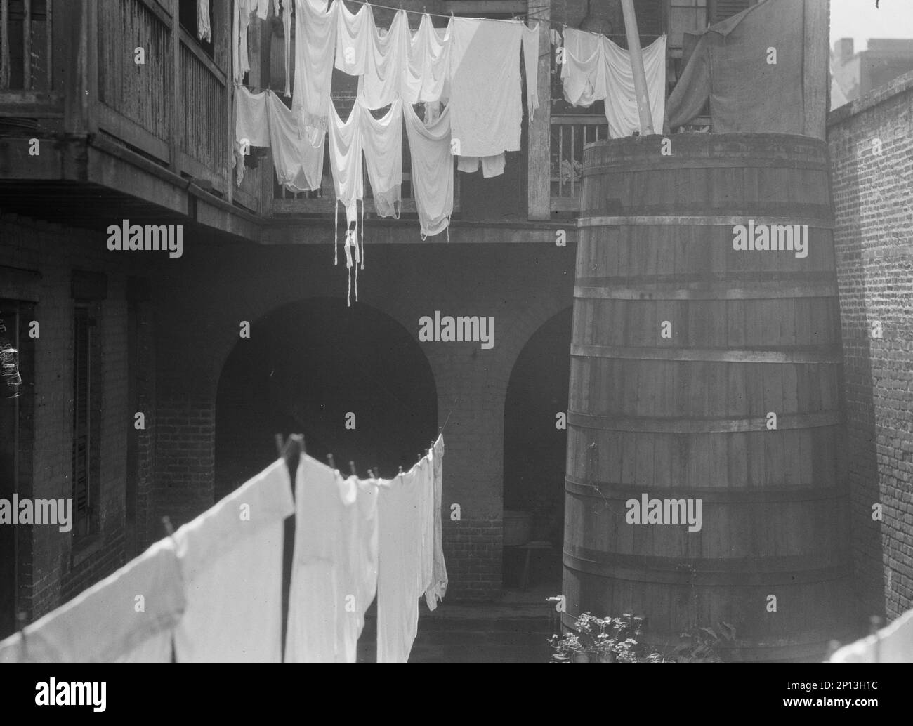 Courtyard with cistern and hanging laundry, New Orleans, between 1920 ...