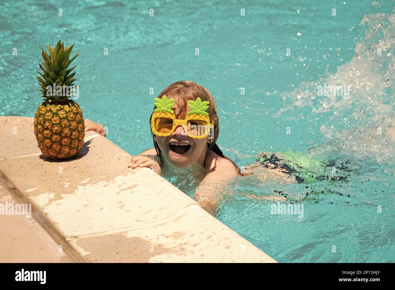 Happy child playing in swimming pool. Summer kids vacation. Little kid ...