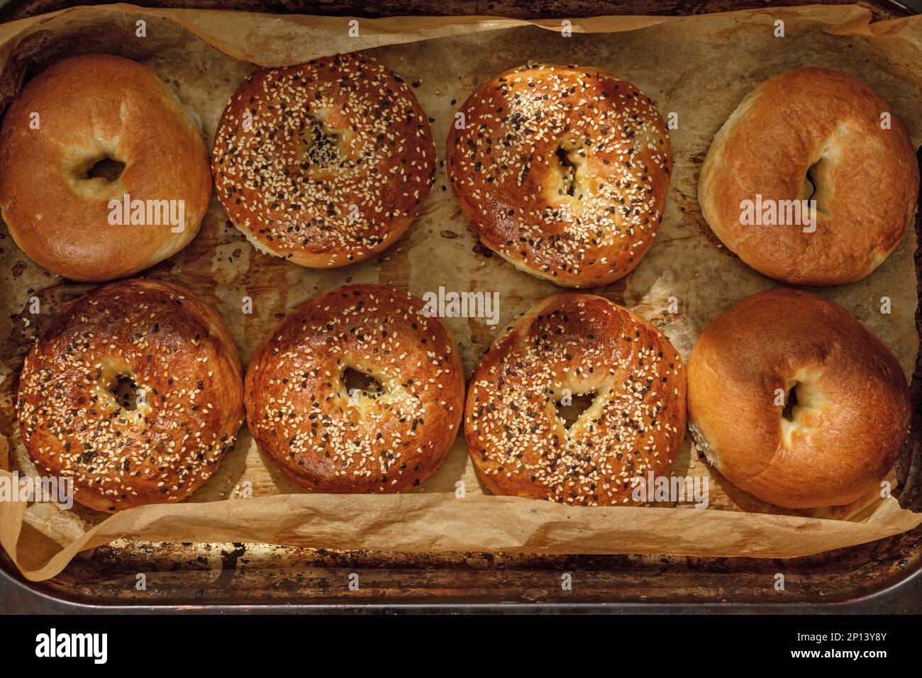 Full frame background of freshly made bagels on baking paper. Fresh and ...