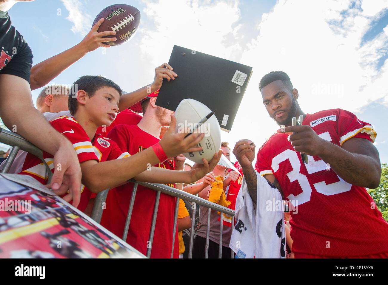 Kansas City Chiefs running back Charcandrick West, right, gives ...