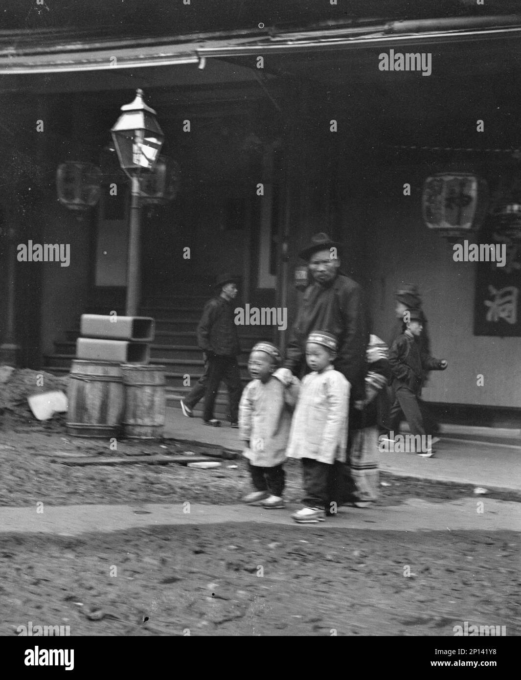 Man and two children crossing a street, Chinatown, San Francisco ...