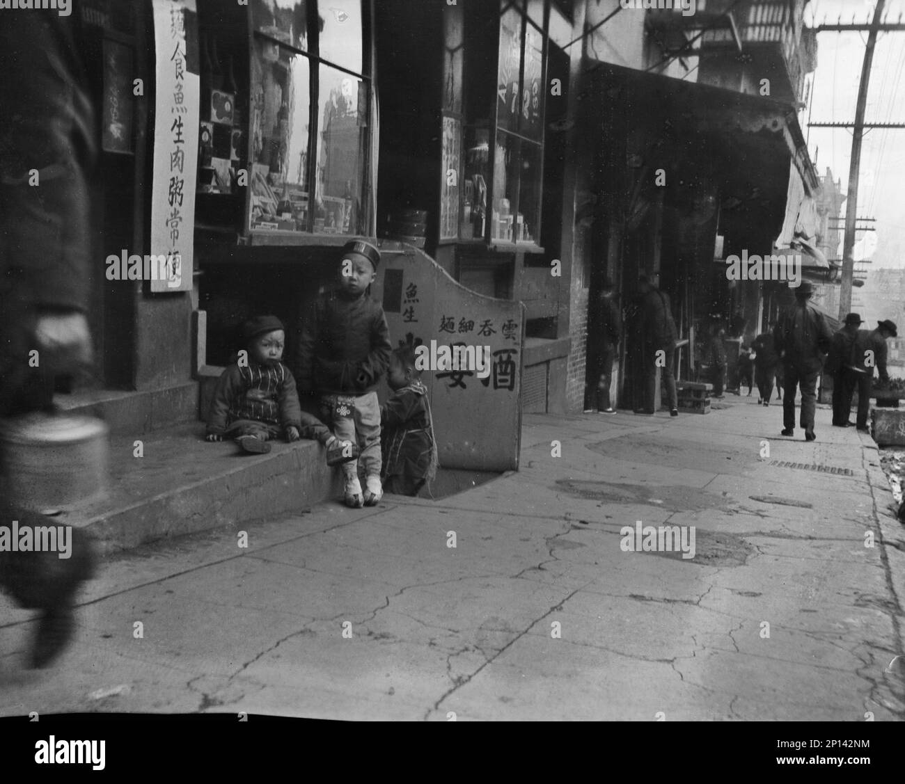 Three children in front of a cellar door, Chinatown, San Francisco ...