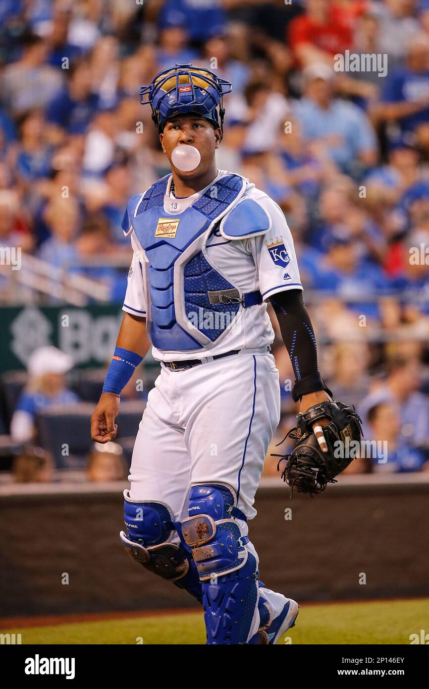 Kansas City Royals catcher Salvador Perez blows a bubble as he walks to ...