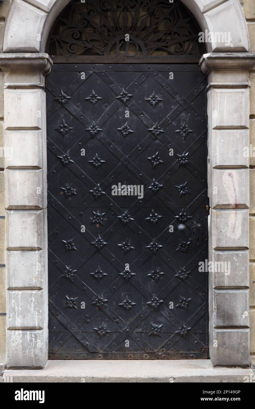 Old massive swinging metal forged doors Stock Photo - Alamy