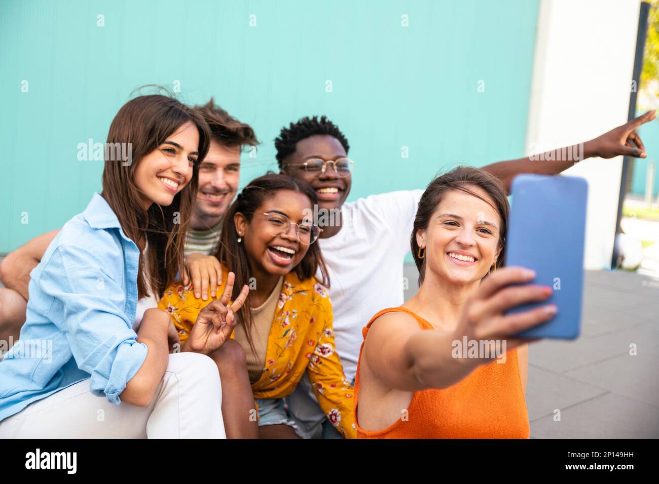 Multiracial group of friends making a selfie with phone in the ...
