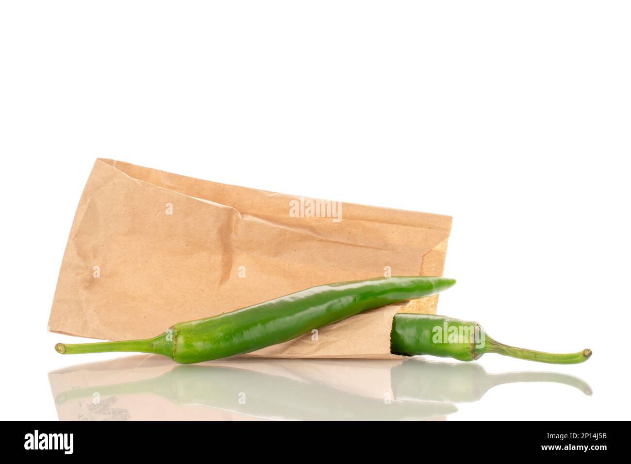 Two green spicy pepper with a paper bag, a macro, isolated on a white ...
