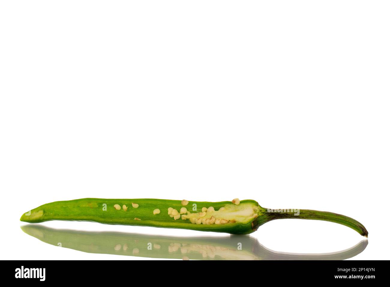 One half of the green spicy pepper, macro, isolated on a white ...