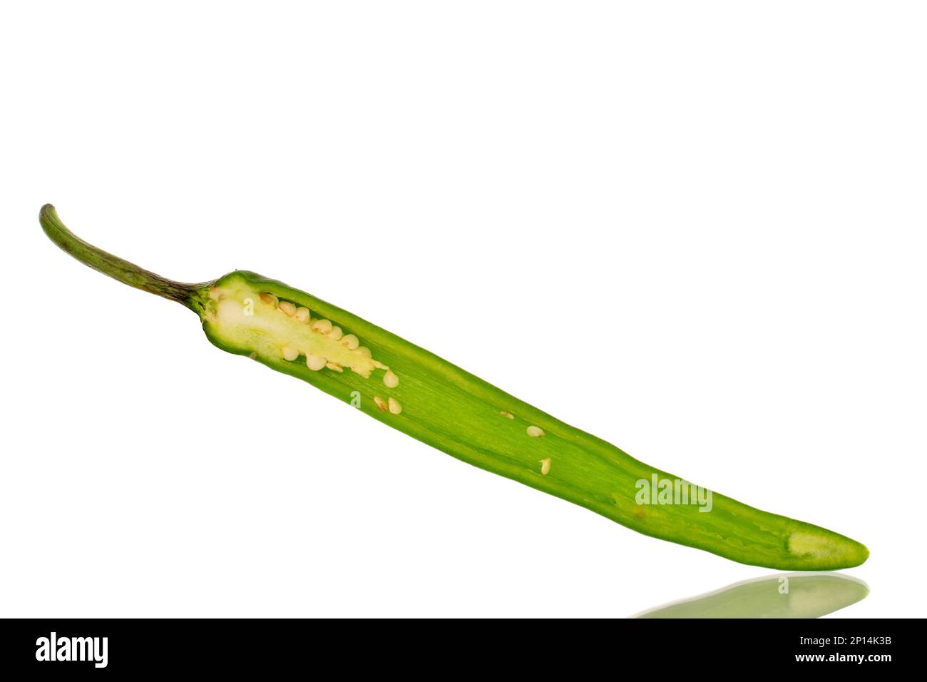 One half of the green spicy pepper, macro, isolated on a white ...
