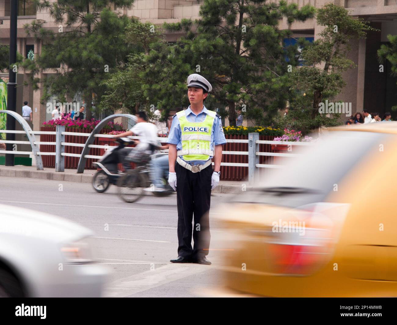 Police traffic officer policeman at a busy road junction in the Chinese city of Xi'an. PRC ...