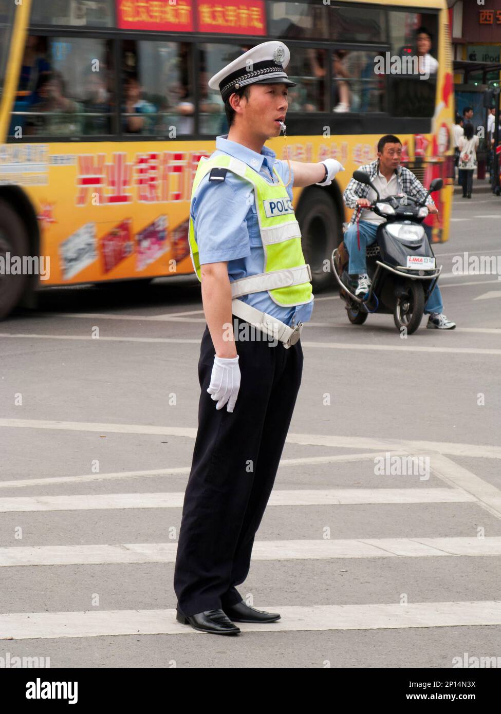 Police traffic officer policeman at a busy road junction in the Chinese city of Xi'an. PRC ...