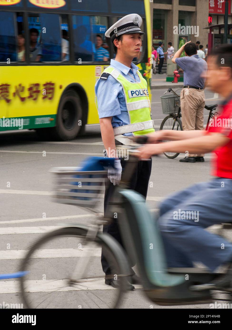 Police traffic officer policeman at a busy road junction in the Chinese ...