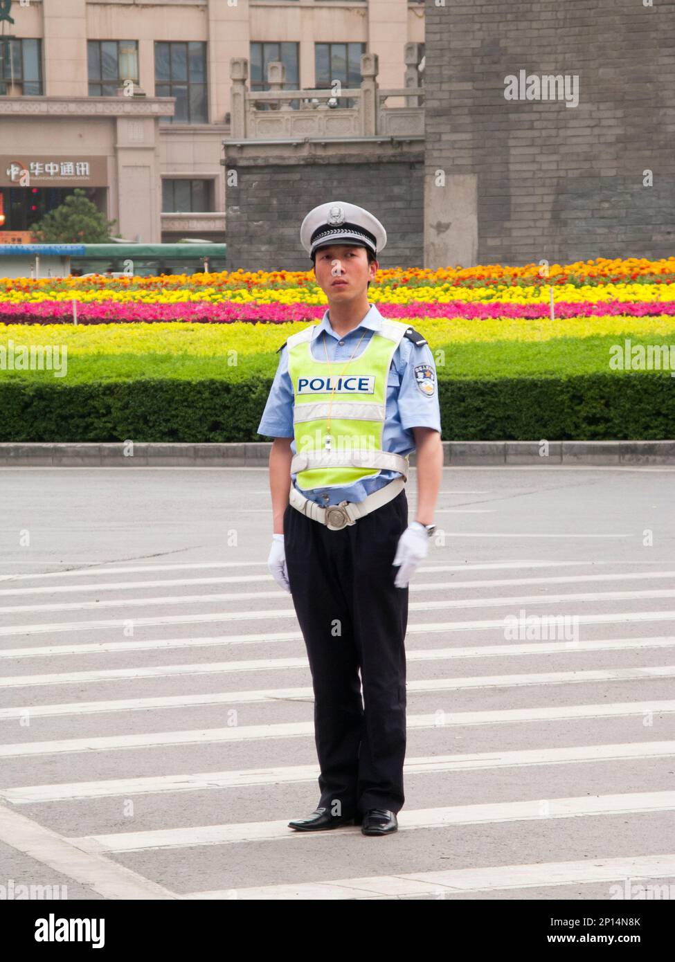Police traffic officer policeman at a momentarily quiet road junction ...