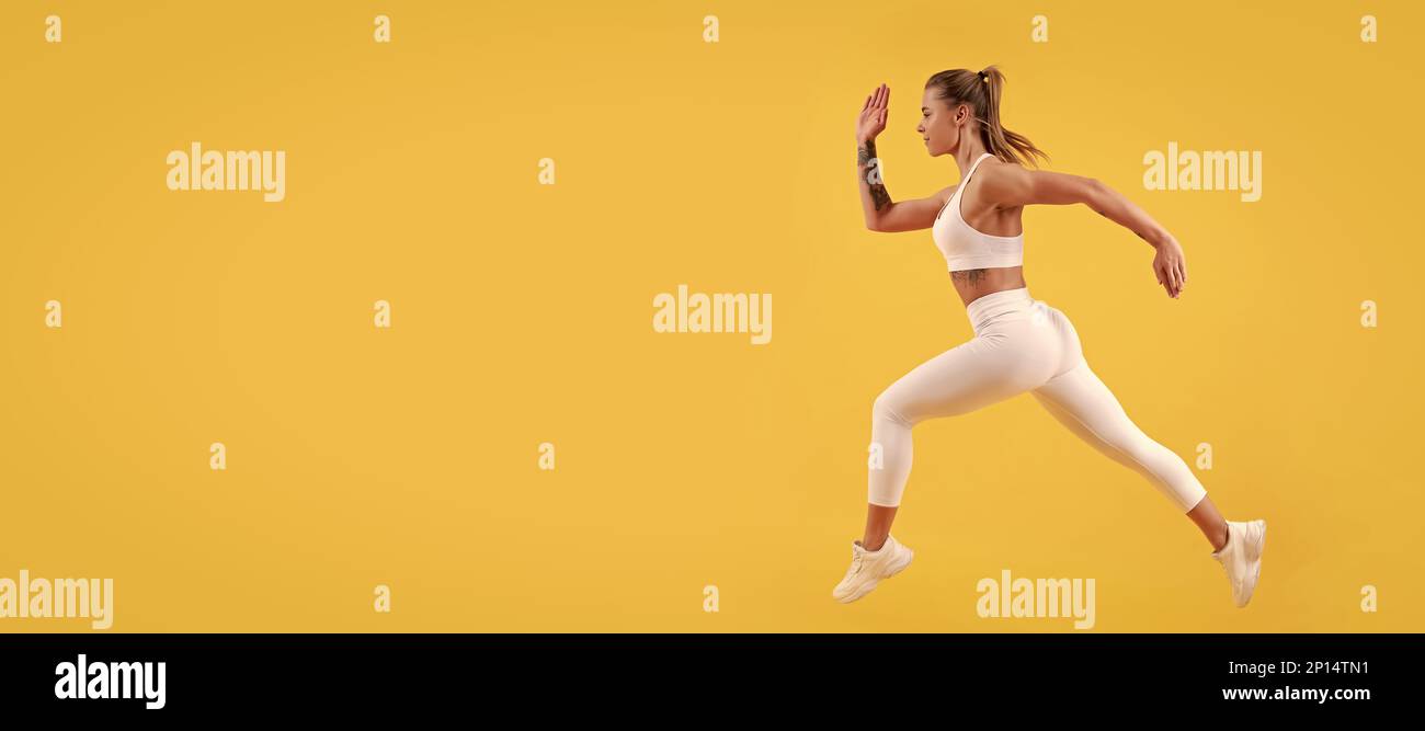 active sport girl runner running on yellow background. Woman jumping ...