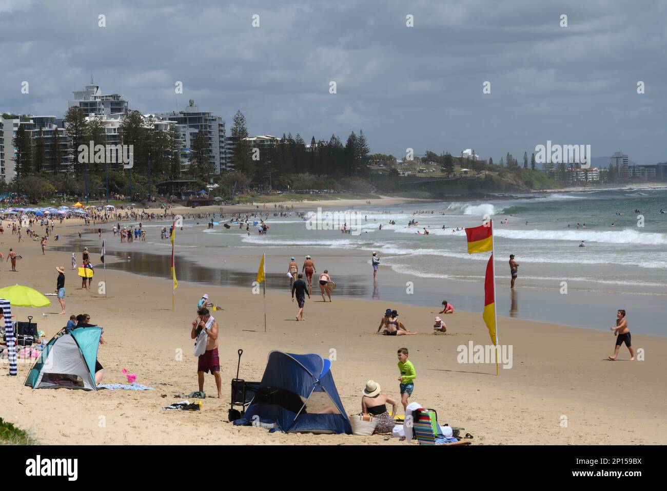 The Beach at Mooloolaba. Swimmers and sun seekers enjoy the sand and ...