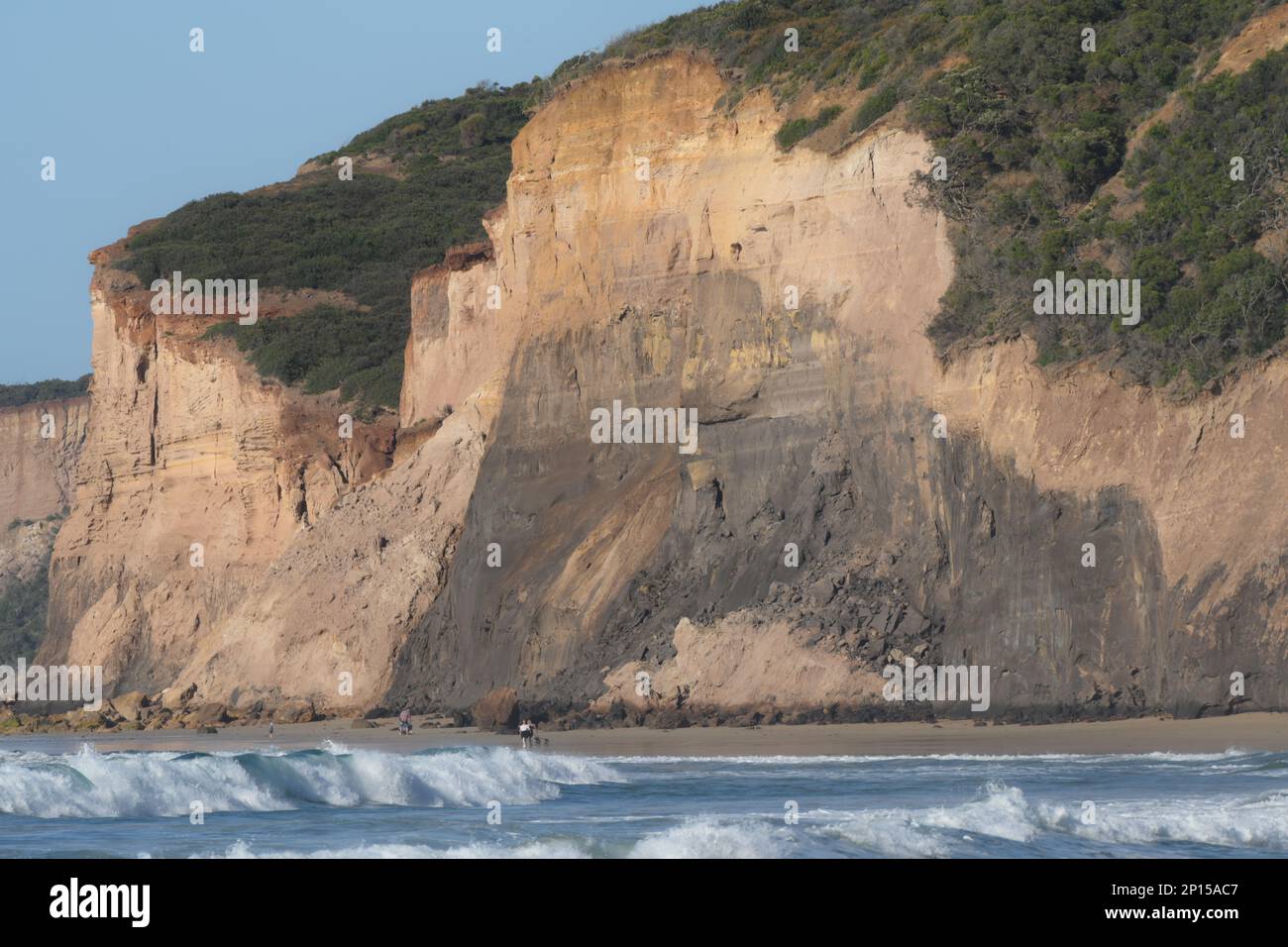 People on the beach near rock fall at South beach Bells, Victoria ...