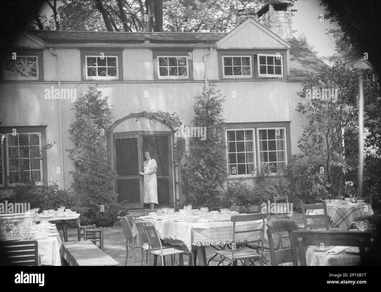 Mrs. Mary Benson standing at the entrance to her house, between 1933 ...