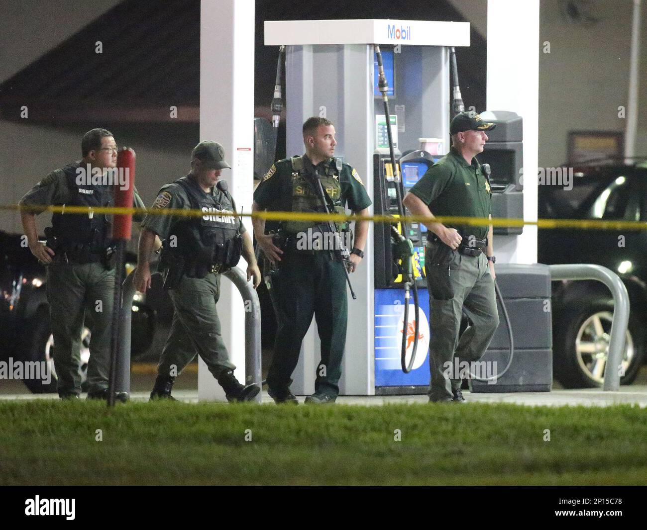 Law enforcement officials work the scene near where multiple Baton ...