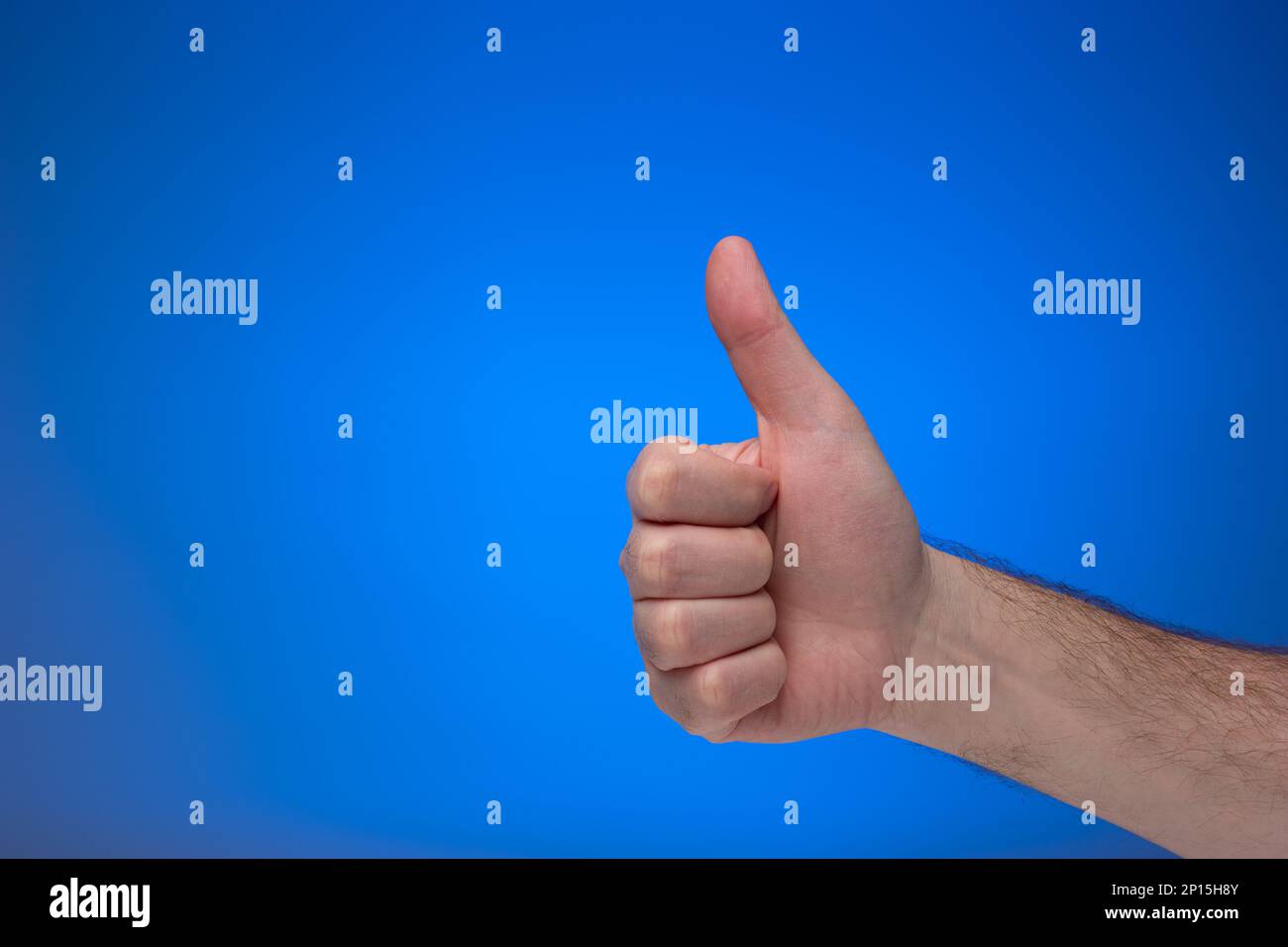 Thumb's up like gesture made by Caucasian male hand. Close up studio ...