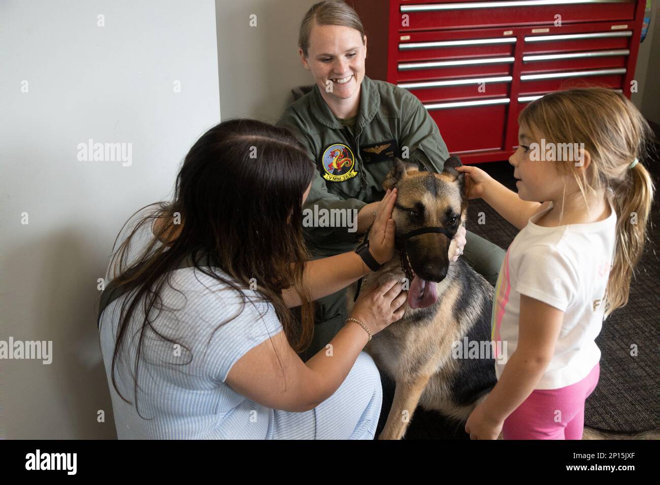 A mother and child pet a dog during a family day event at Marine Medium ...