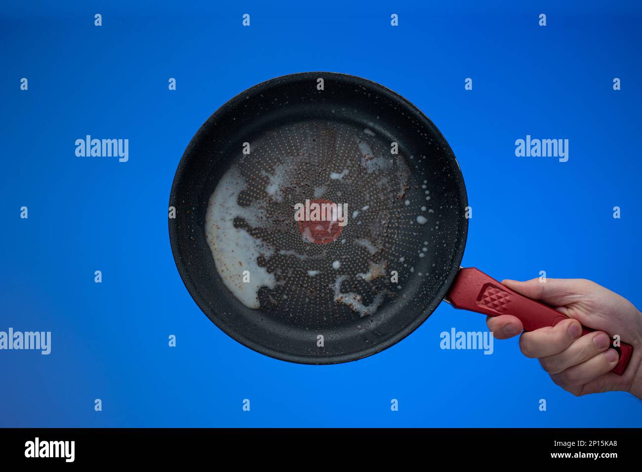 Dirty oily burnt metal frying pan held in hand by male hand Stock Photo ...