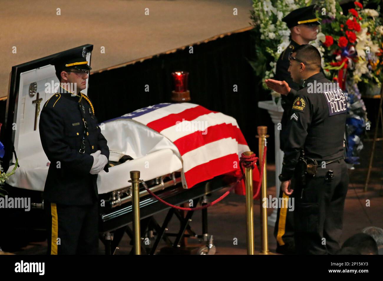 A Dallas police officer salutes fallen Dallas police officer Patrick ...