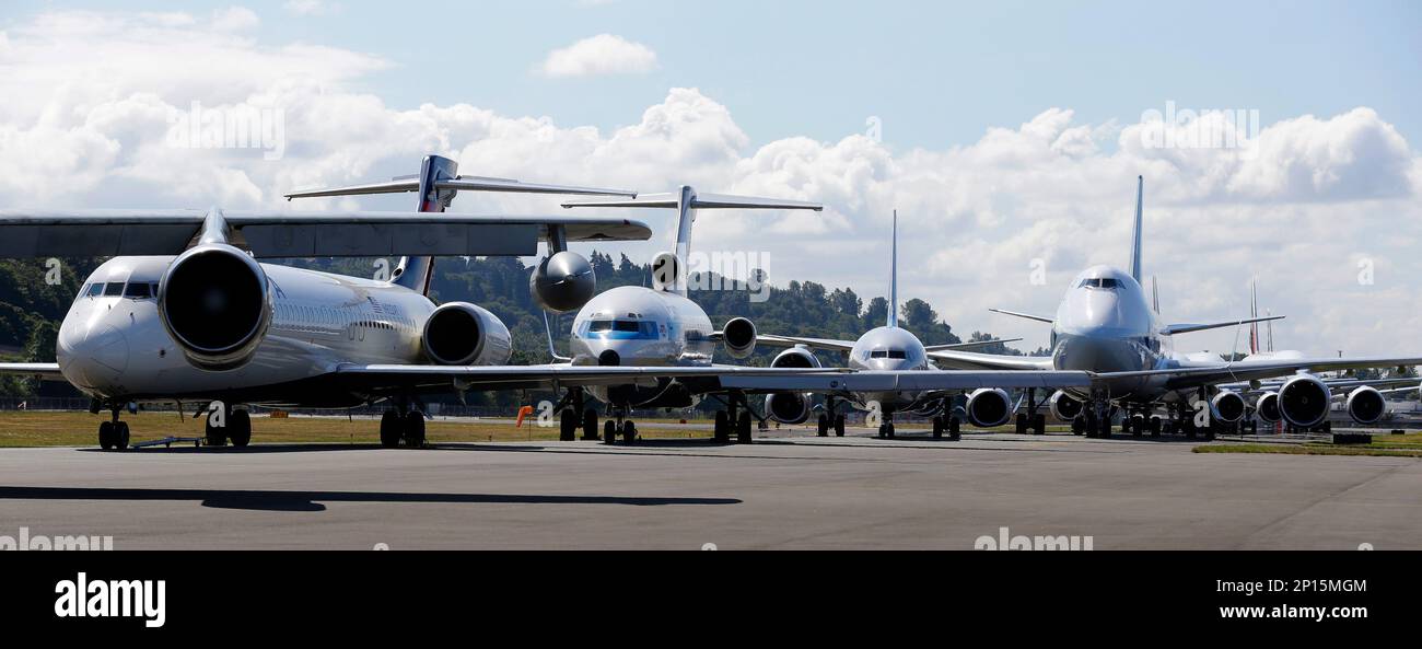 Boeing 7-series passenger airplanes sit parked in a lineup formation ...