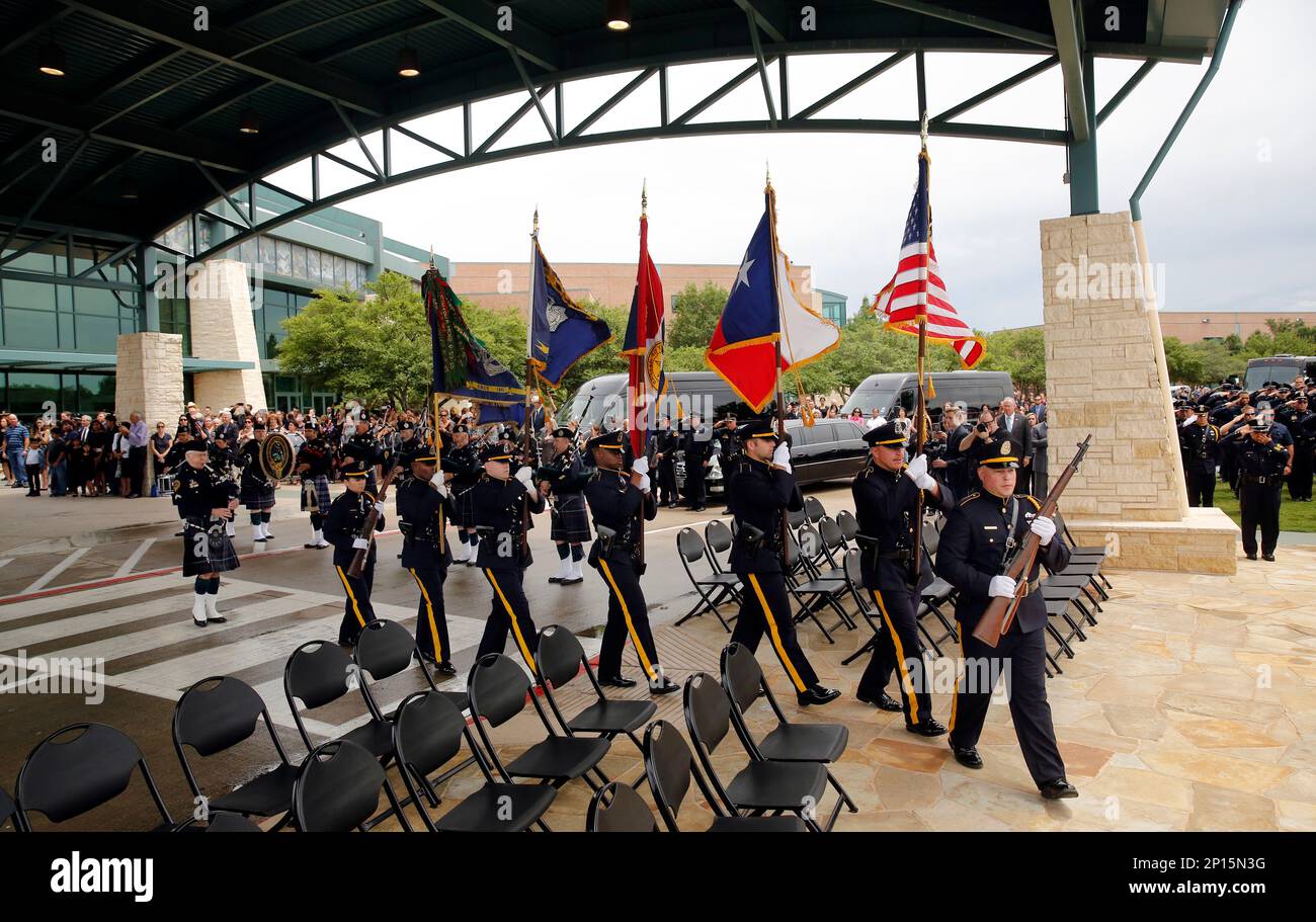 The Dallas Police Honor Guard carry the colors into a ceremony for ...