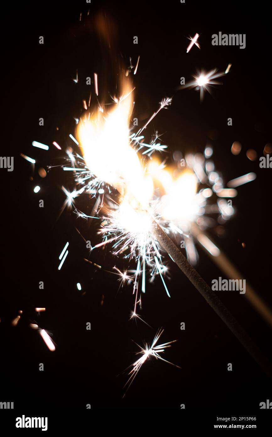 Sparkling firecrackers burning close up shot isolated on black boken ...