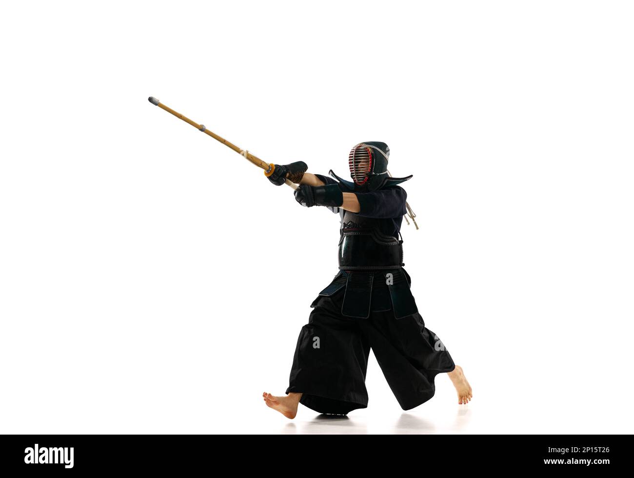 Man, professional kendo athlete in motion, in uniform training with ...