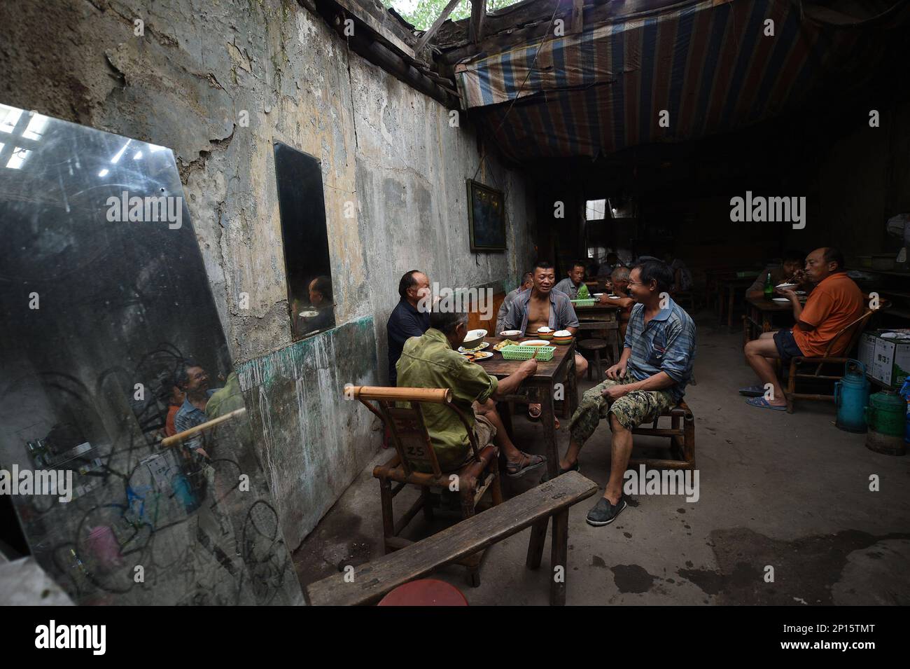 Local residents enjoy food at an old restaurant in Santai county in ...