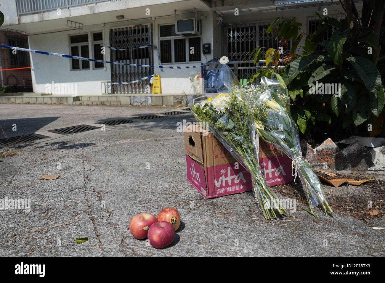 Flower bouquets and some fruits are seen to be placed outside the crime ...