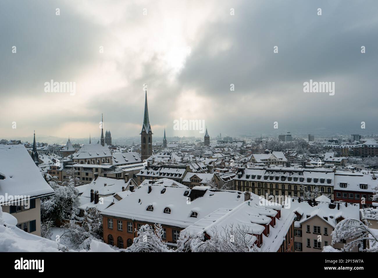 Snow covered old town Zurich with church bell tower winter time cloudy ...