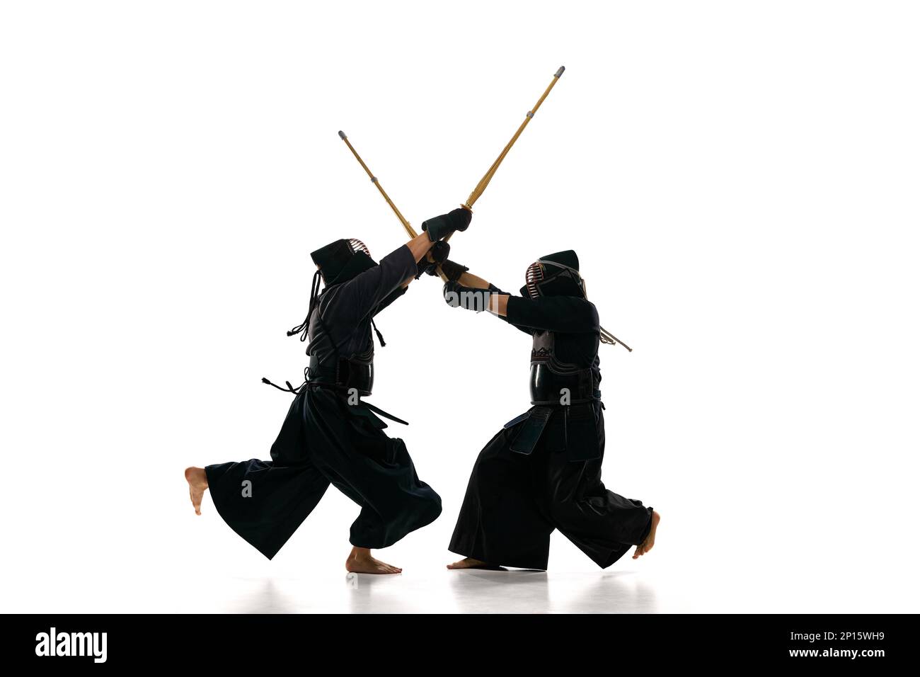 Dynamic image of two men, professional kendo athletes in uniform with ...