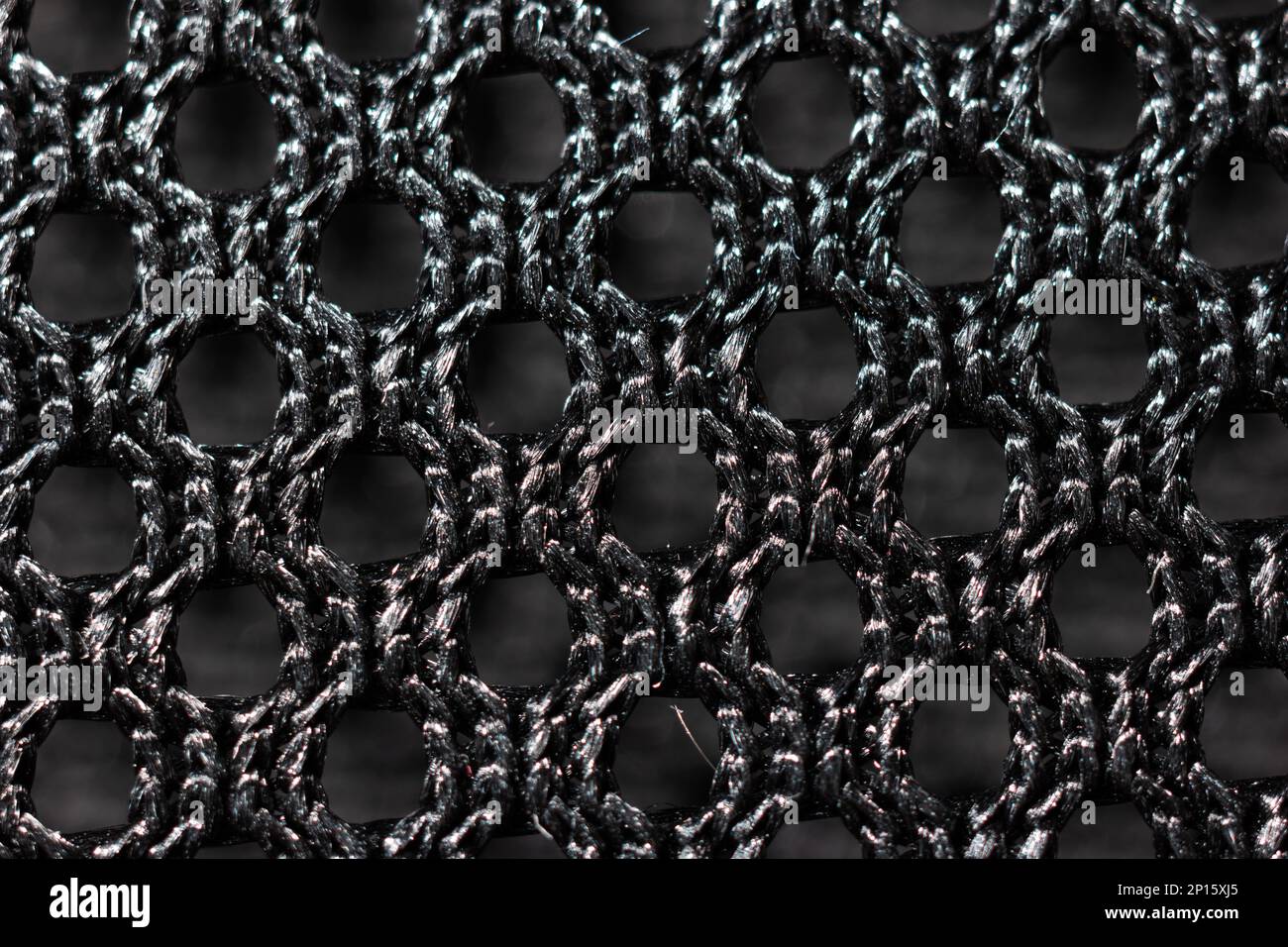Black fabric chair backrest mesh net weave extreme macro front view ...