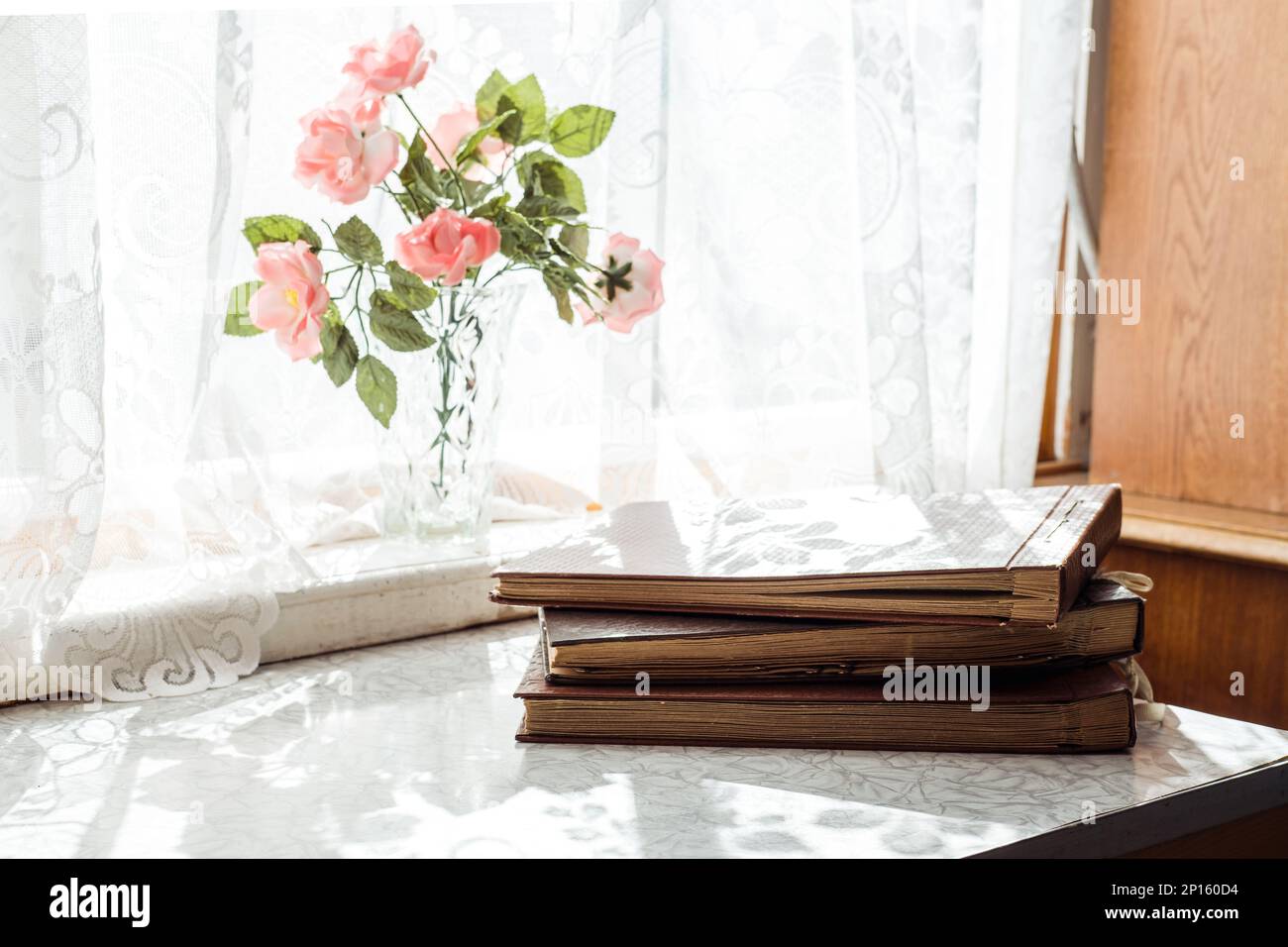 vintage brown photo albums stand on the table in a stack near the ...
