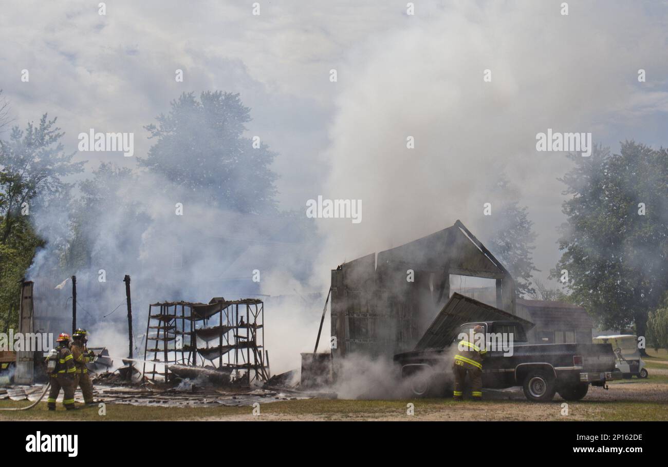 Firefighters battle a pole barn fire at Lakeside Camp Park in Cedar ...