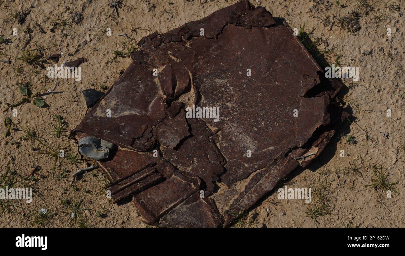 Rusty flattened tin waste, discarded in nature. Negev desert Stock ...