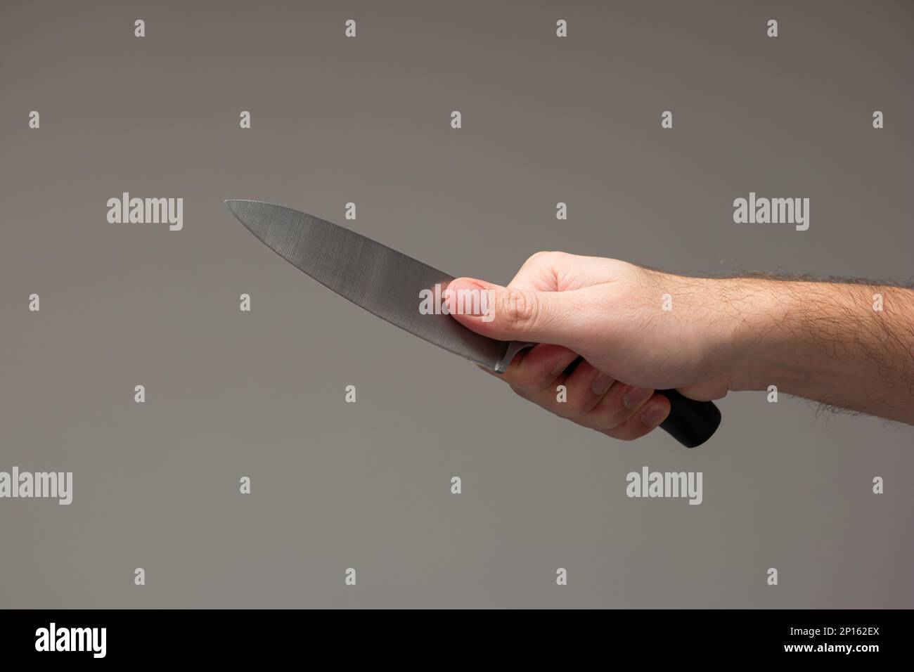 Hand holding large knife cutting hi-res stock photography and images ...