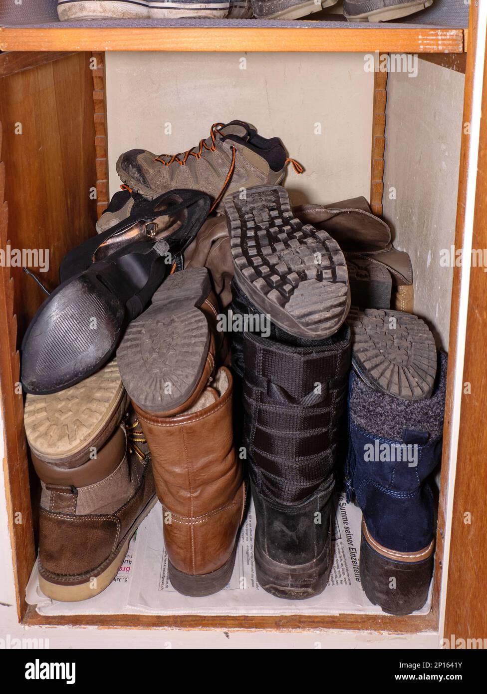 Household shoe rack cabinet with a variety of stacked used shoes Stock ...