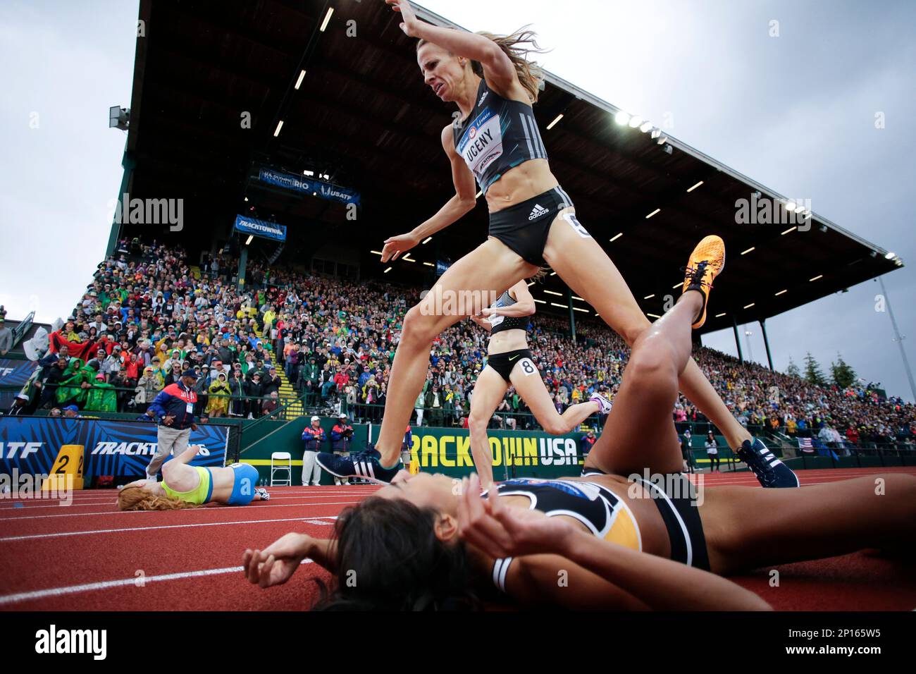 Morgan Uceny, top, steps over Brenda Martinez at the finish line in the ...