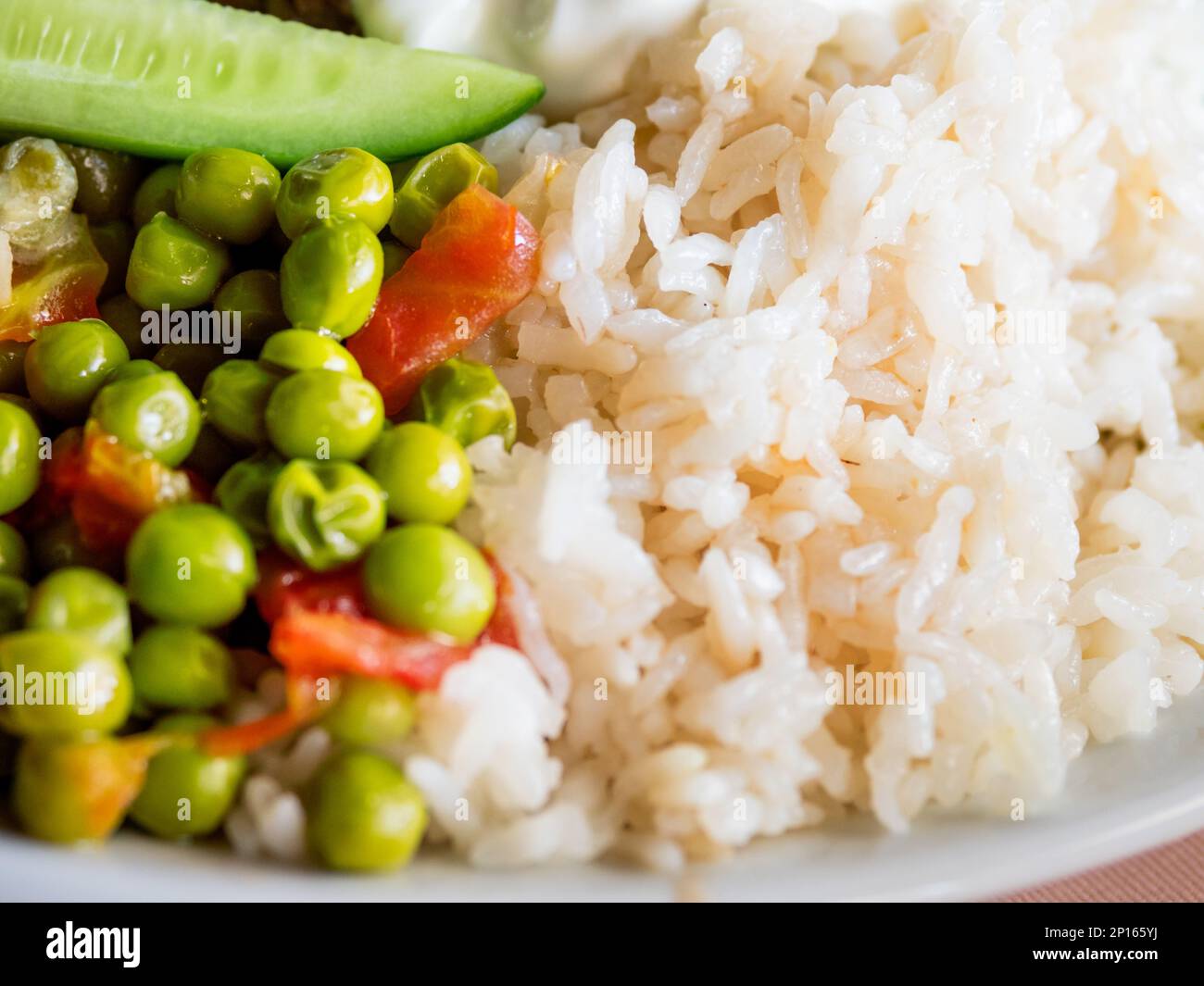 Healthy dinner - plate full of stewed vegetables, rice and peas Stock ...