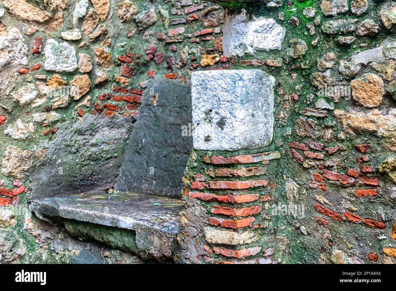 A cement bench in the stone wall of the ancient fortified building ...
